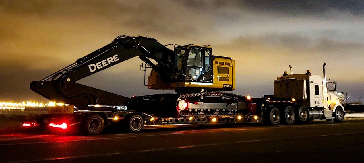Backhoe Hauling. Construction Equipment Shipping Company.